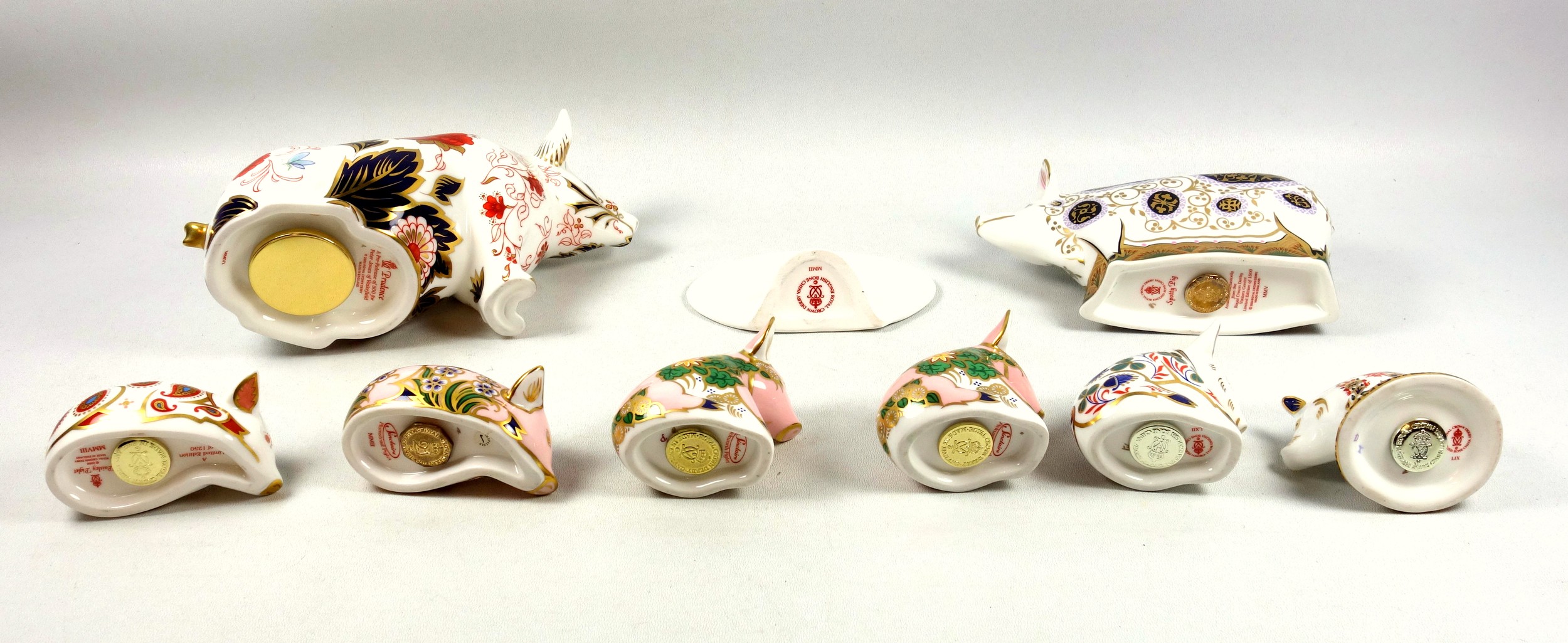 Royal Crown Derby "Prudence" piggy bank, W.18cm; 7 other pigs, and a ...