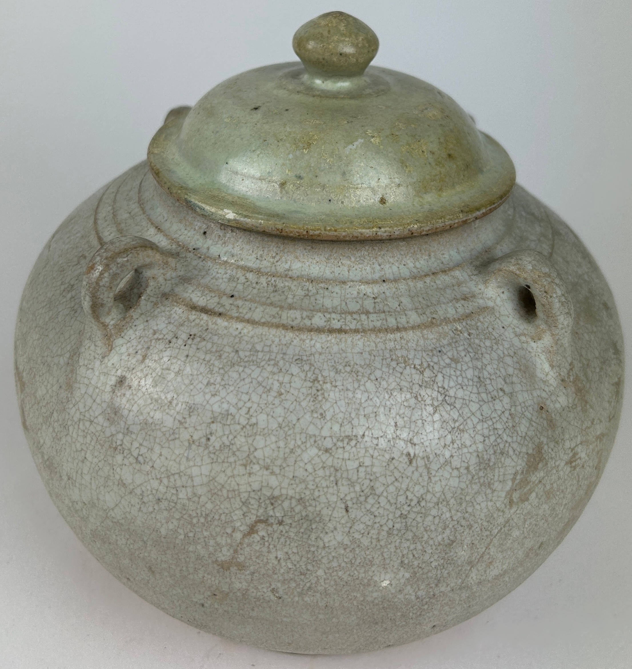 A CHINESE STONEWARE POT WITH LID AND FOUR LOOP HANDLES, the pot ...