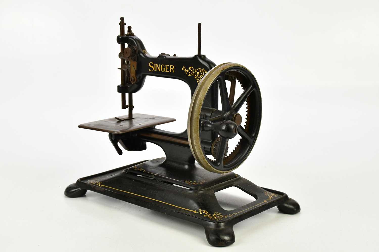 THE SINGER MANUFACTURING CO; an early sewing machine, with gilt ...