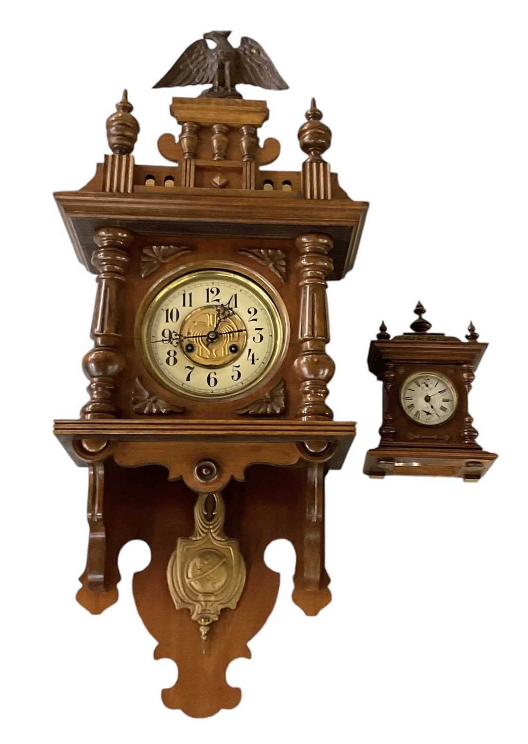 An early 20th century walnut cased wall clock, the top surmounted with ...