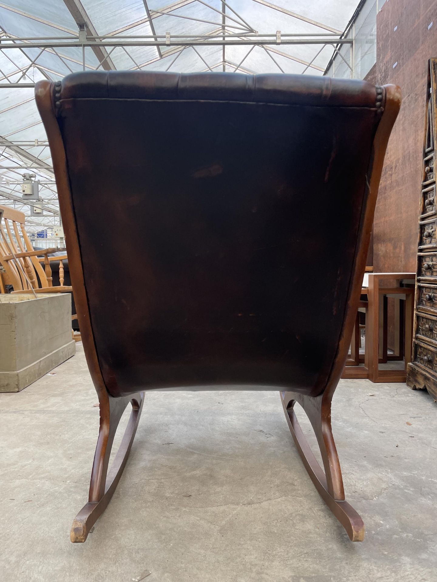 A MODERN SLIPPER LEATHER BUTTON-BACK ROCKING CHAIR
