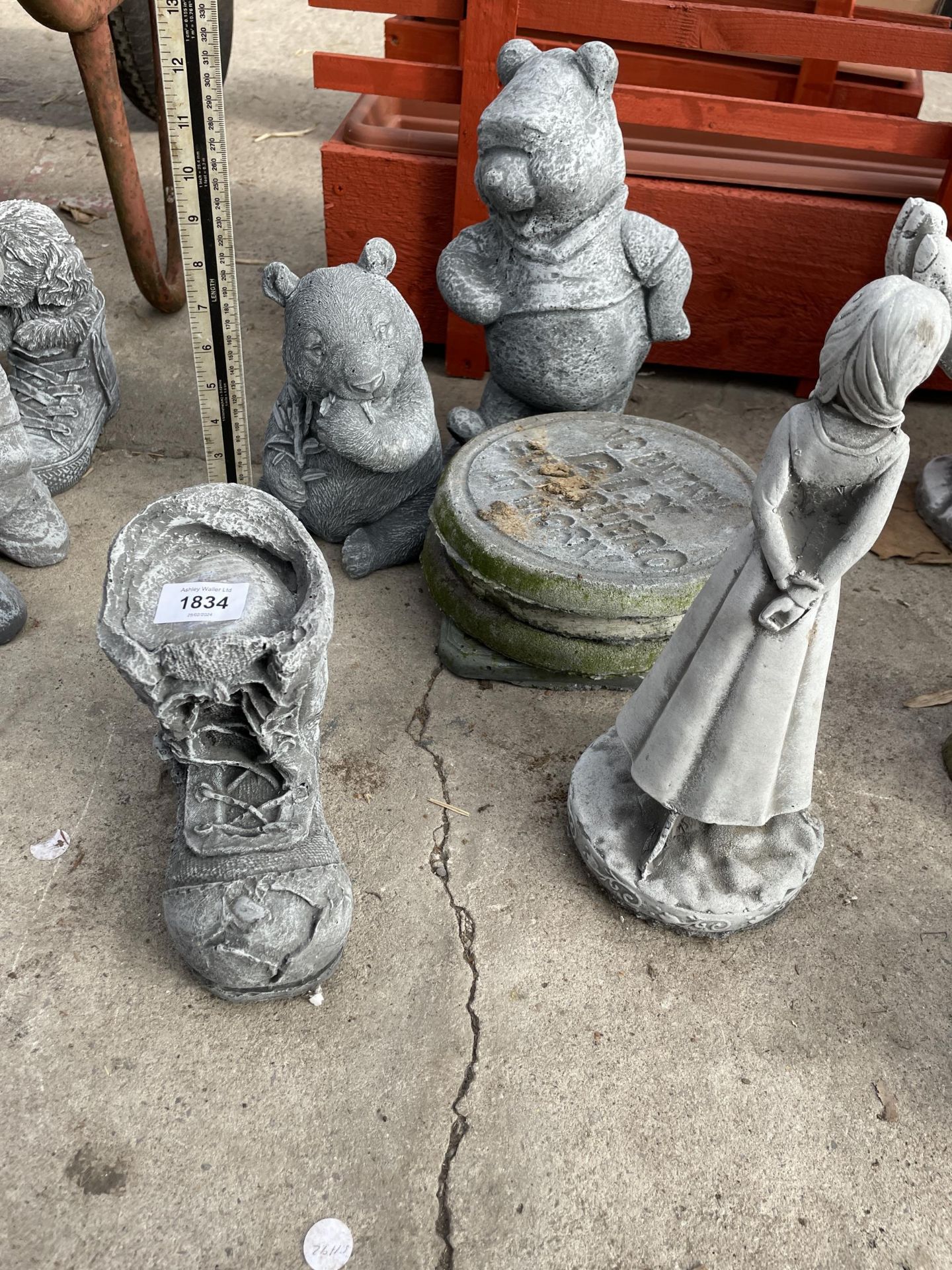 AN ASSORTMENT OF GARDEN CONCRETE FIGURES TO INCLUDE PLAQUES AND WHINNIE ...