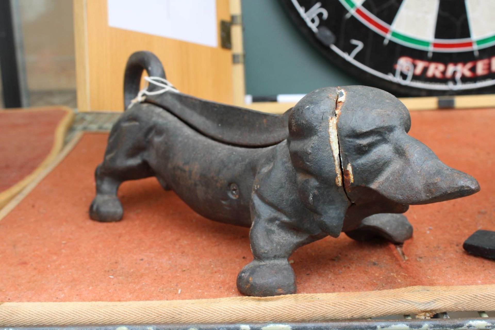 A VINTAGE CAST IRON SAUSAGE DOG DOOR STOP