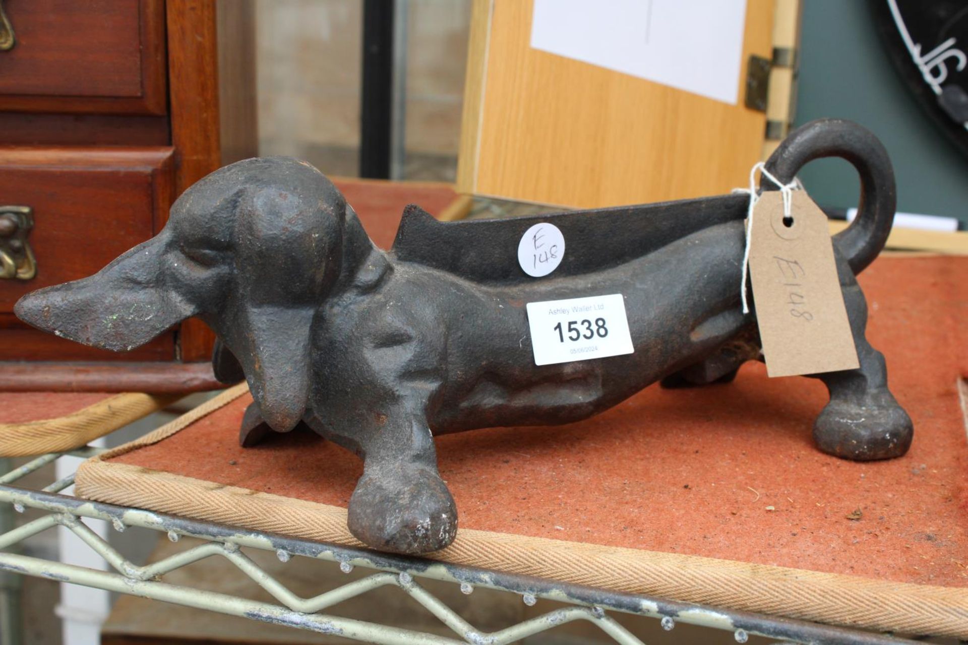 A VINTAGE CAST IRON SAUSAGE DOG DOOR STOP