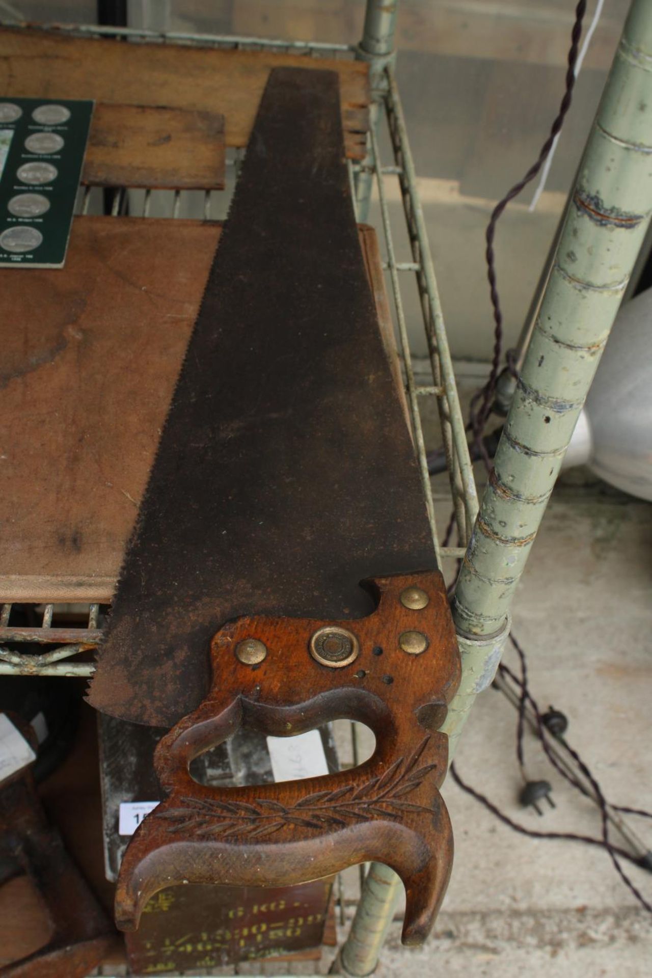 A VINTAGE HAND SAW WITH HAND PAINTED FREE DELIVERY SIGN