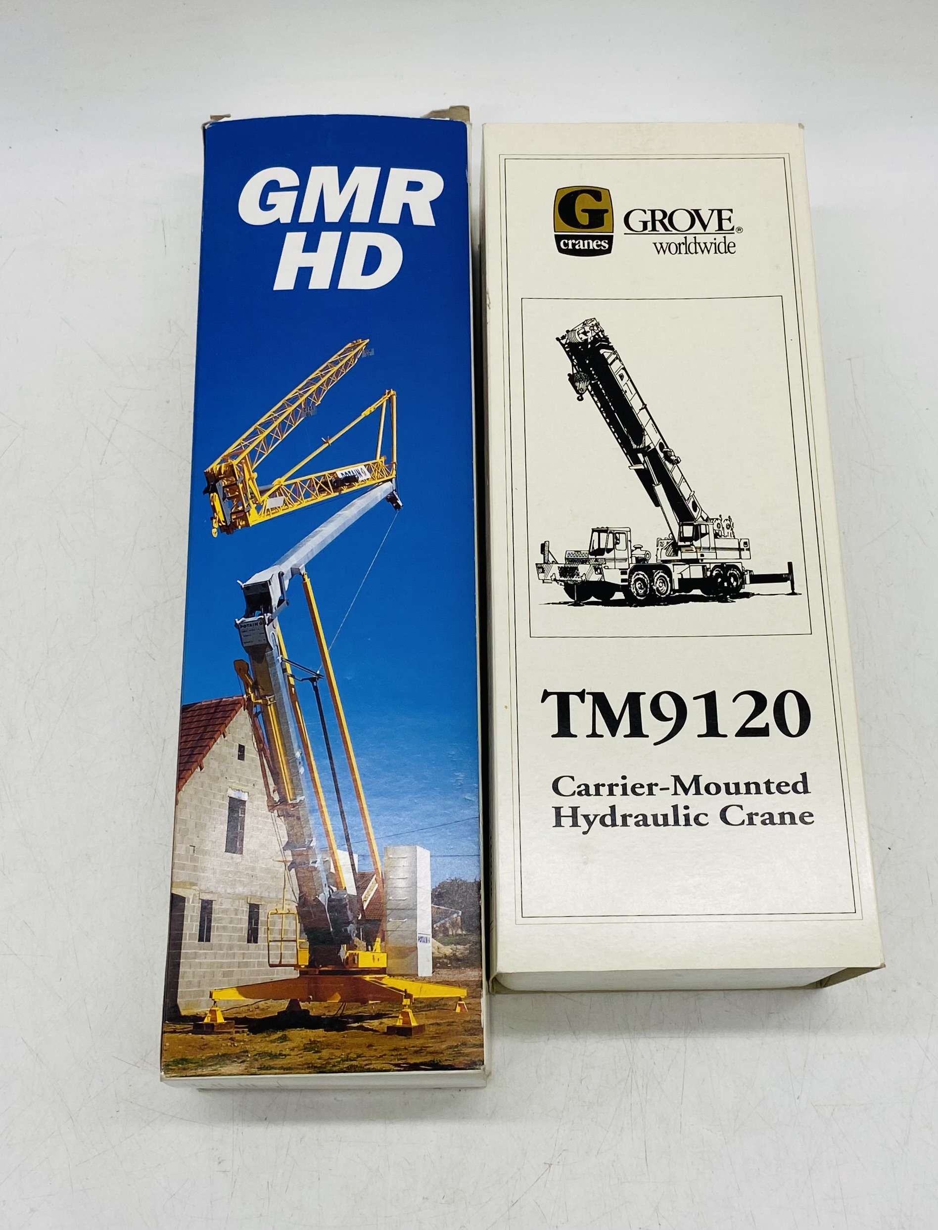 A collection of three boxed die-cast cranes including Grove Worldwide ...