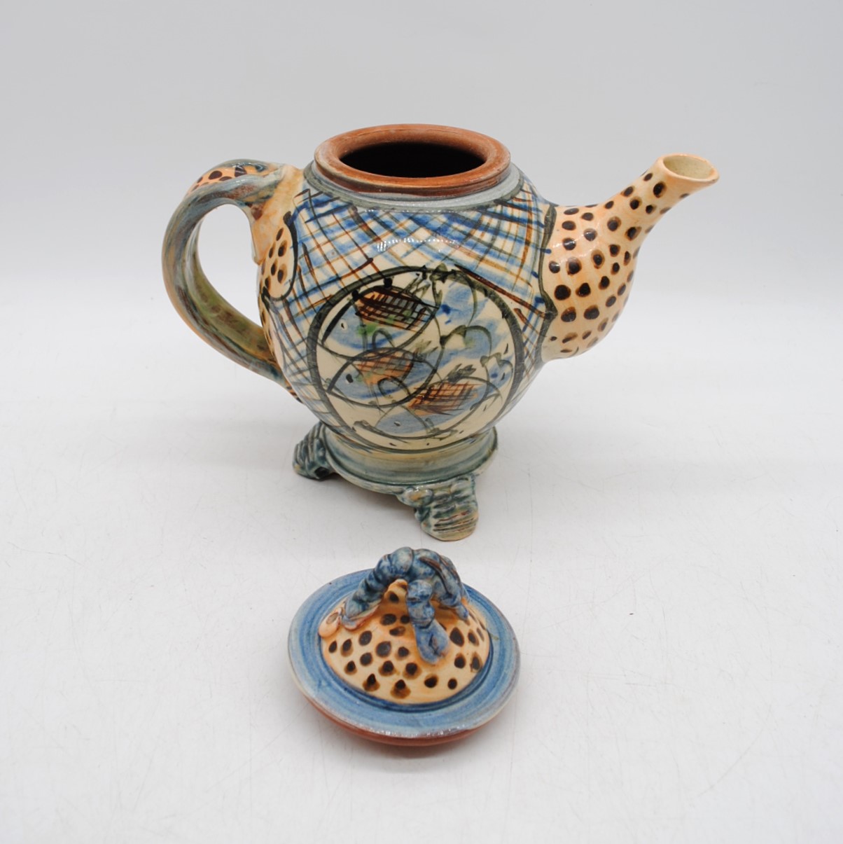 A Willie Carter studio pottery tea pot, with blue lobster finial to ...