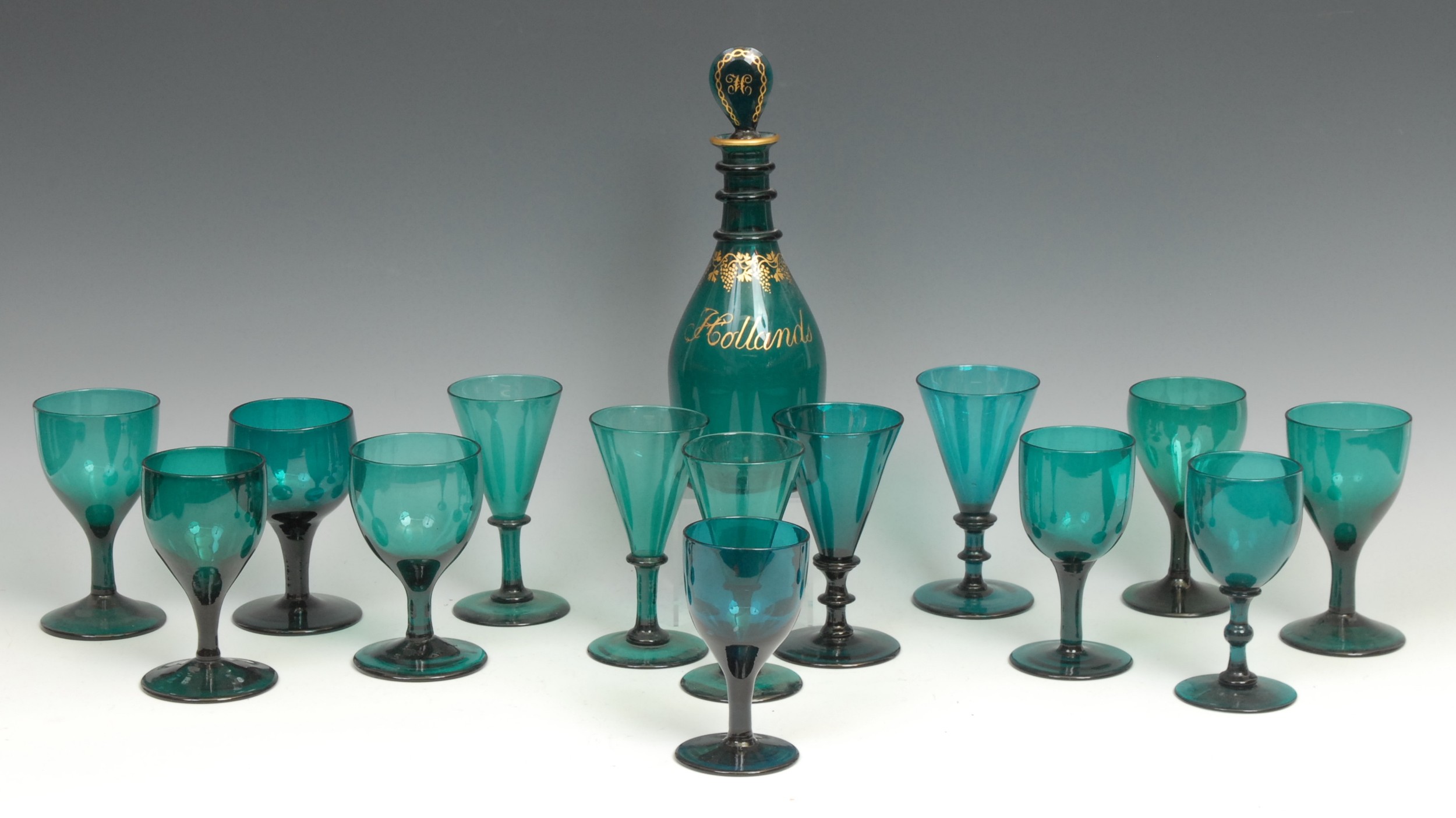 A Georgian turquoise glass gin decanter, gilt decorated with fruiting ...