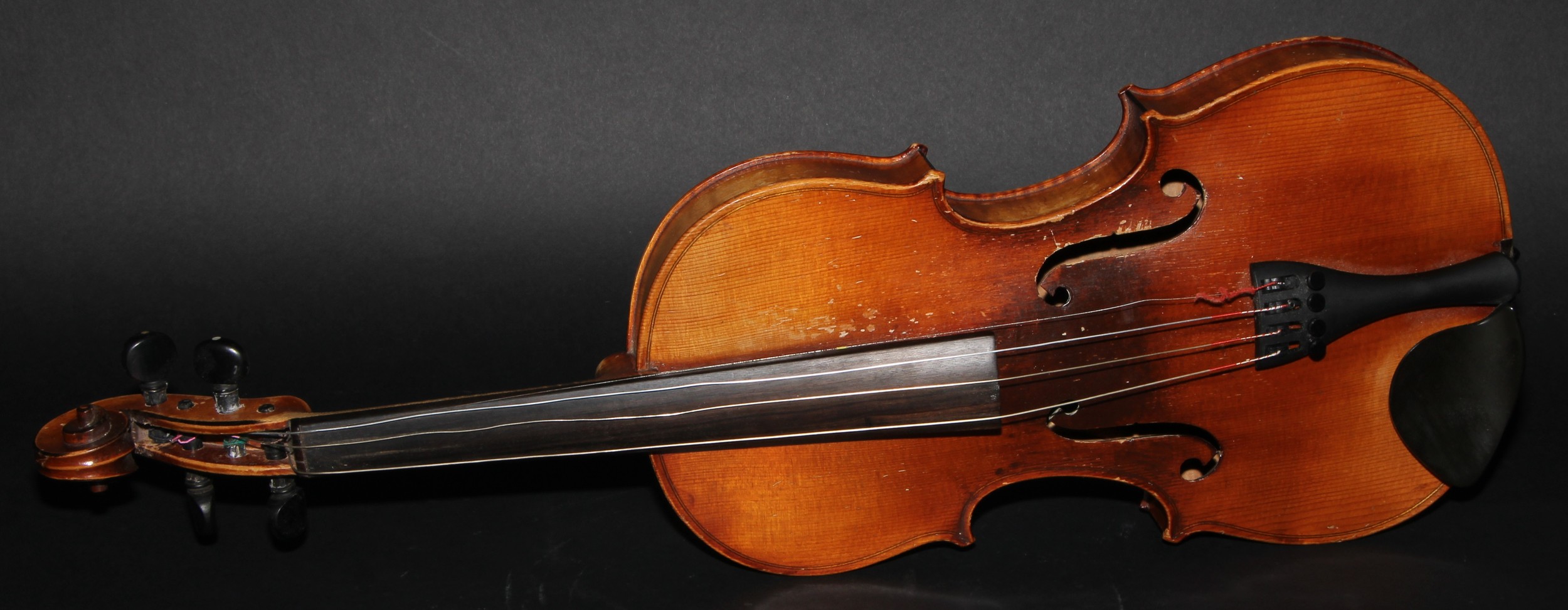 A violin, the two-piece back 36cm long excluding button, paper ...