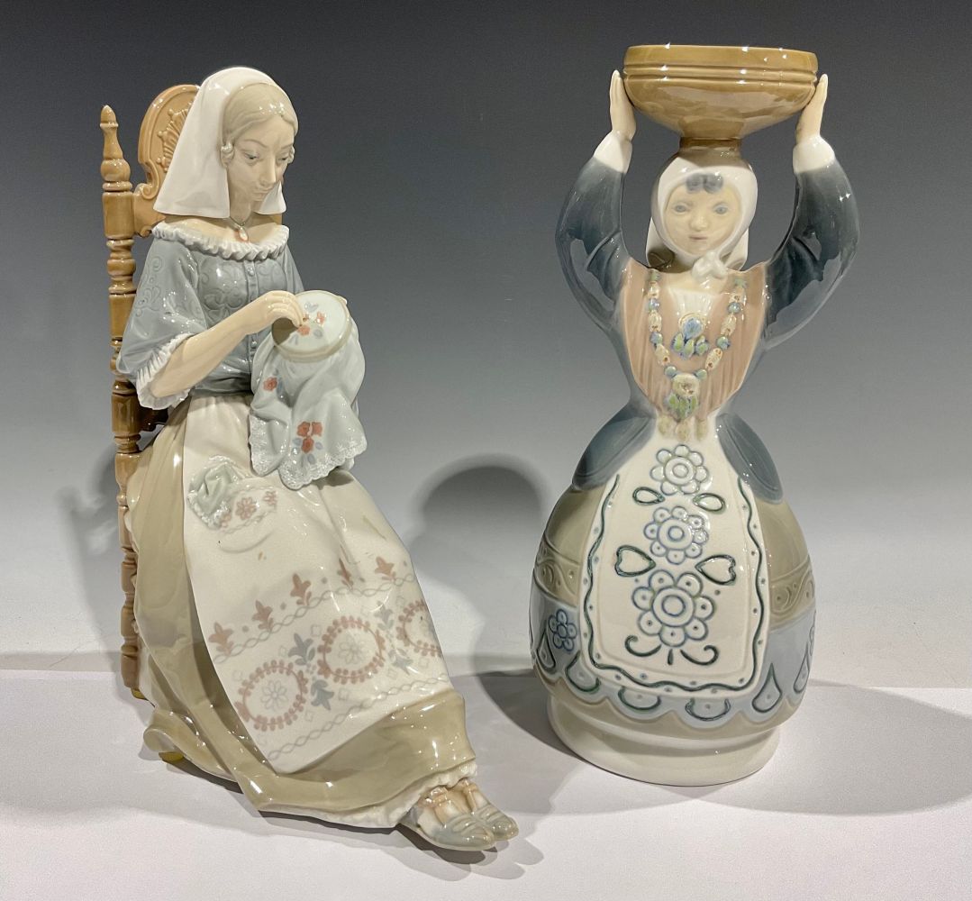 A Lladro porcelain figure, The Embroider, 28.5cm high; another ...