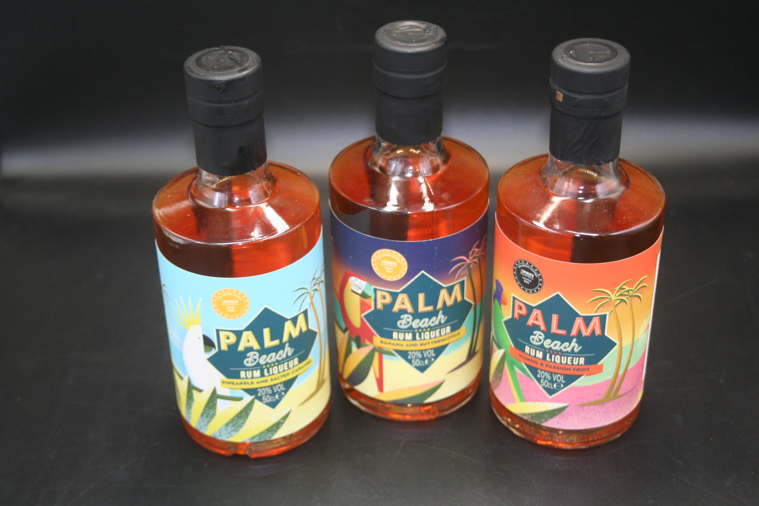 Three bottles of Palm Beach rum liqueur. flavouring to include ...