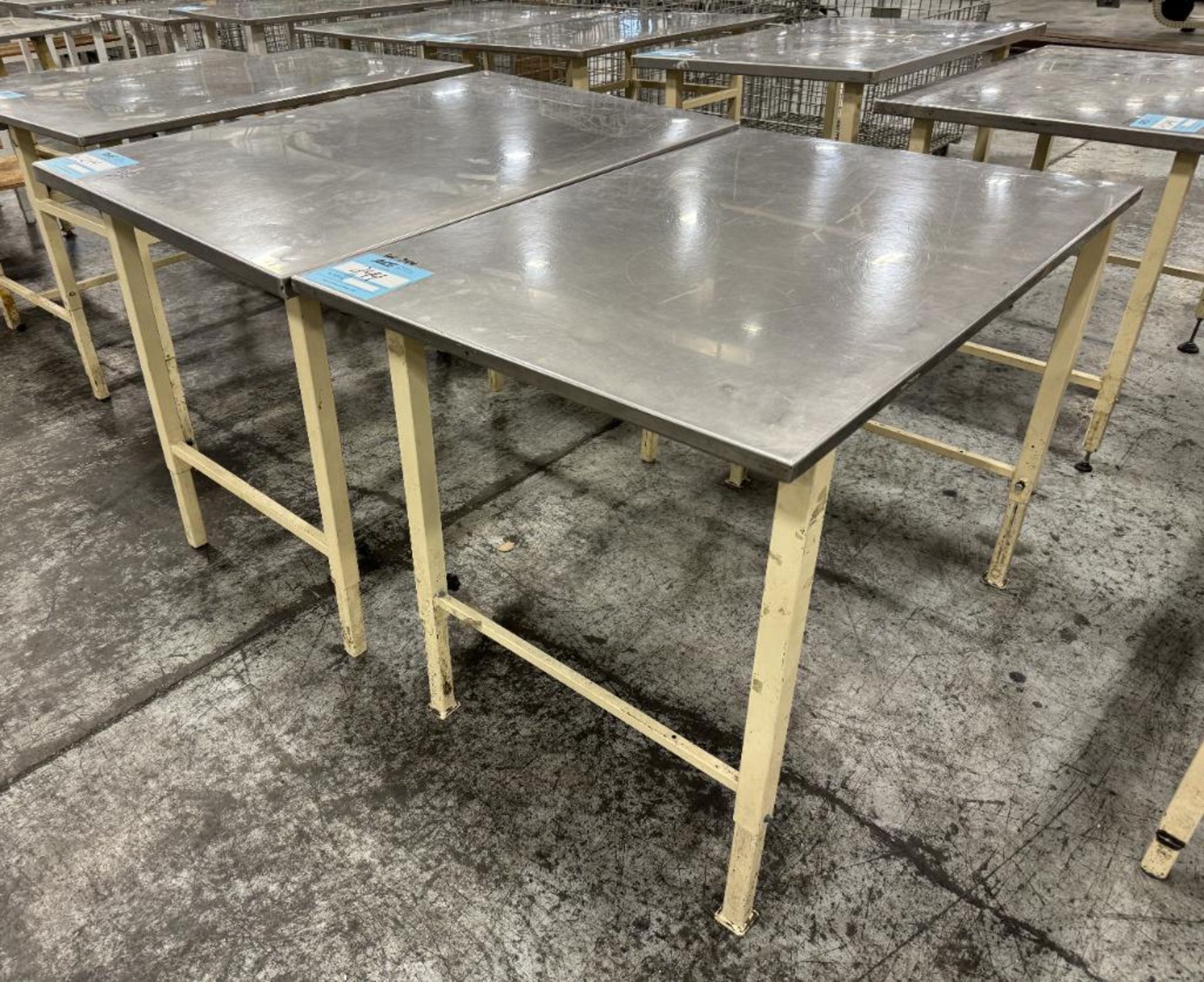 Lot Of (4) Stainless Steel Top Tables. With steel frame.