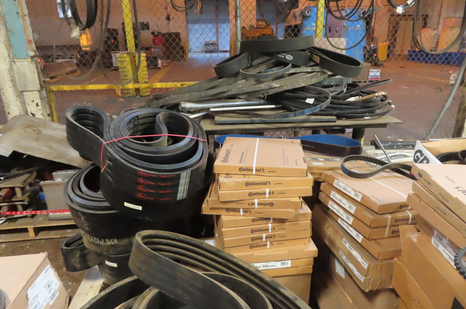 Belts, Lot of assorted belts on (4) pallets, table and hanging hooks ...