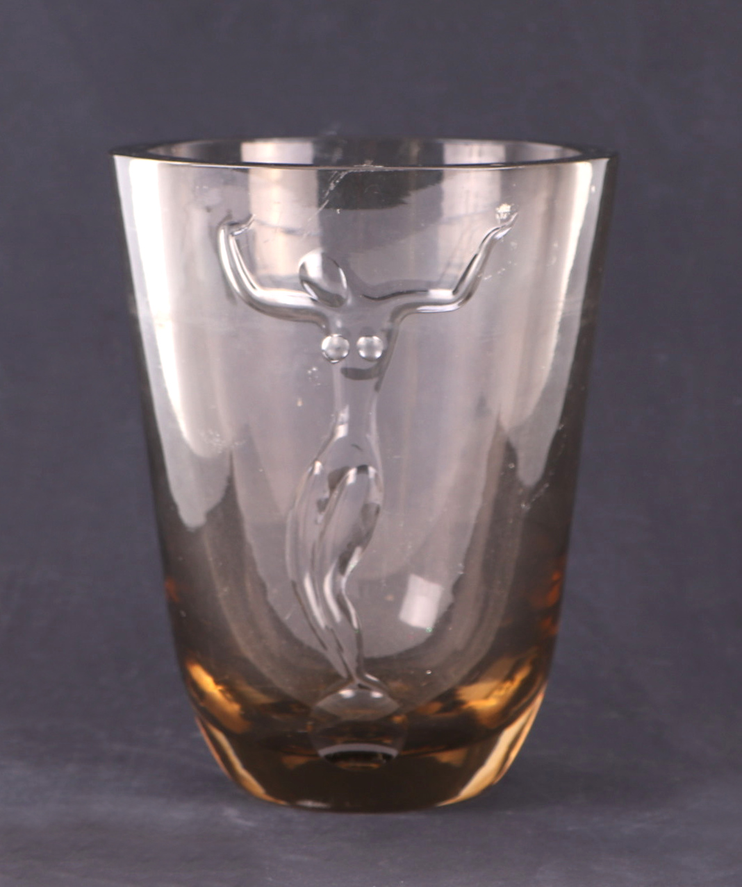 An Orrefors glass vase decorated with a female nude balancing on a wall ...