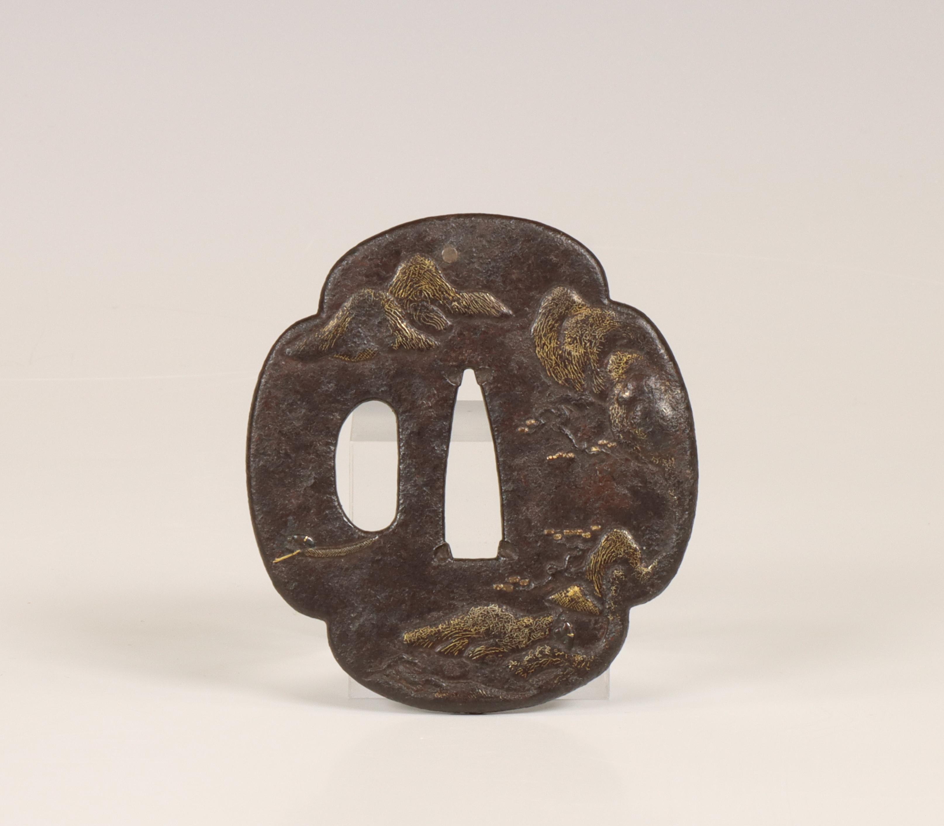 Japan, an iron tsuba, Edo period, 18th-19th century, with gilt ...