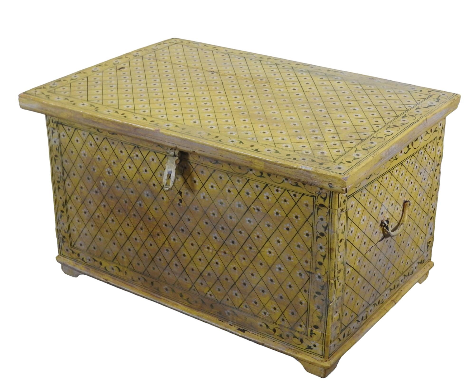 AN INDIAN HARDWOOD TRUNK, painted in a vibrant yellow with a floral ...