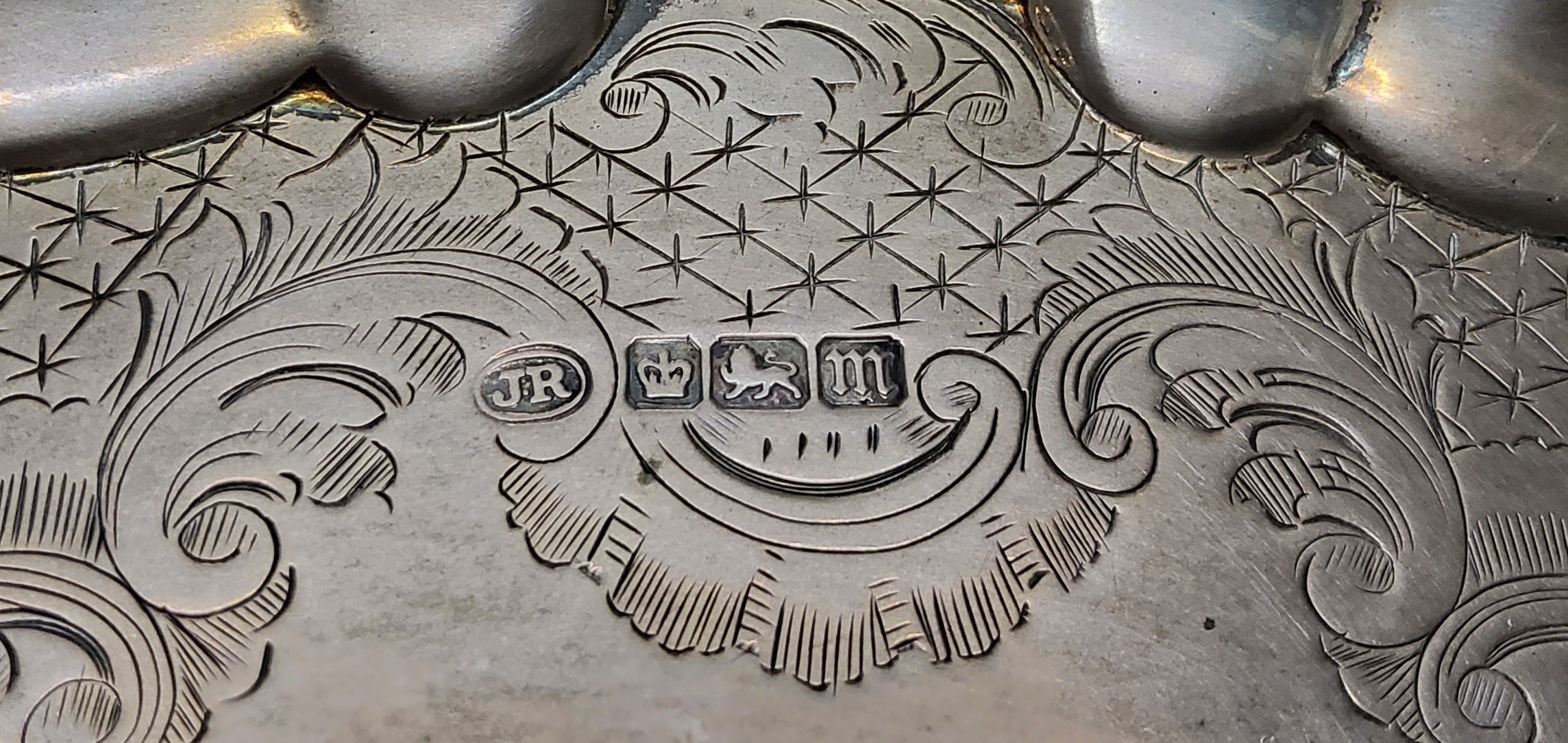 An Edwardian silver shaped circular salver, central vacant cartouche ...