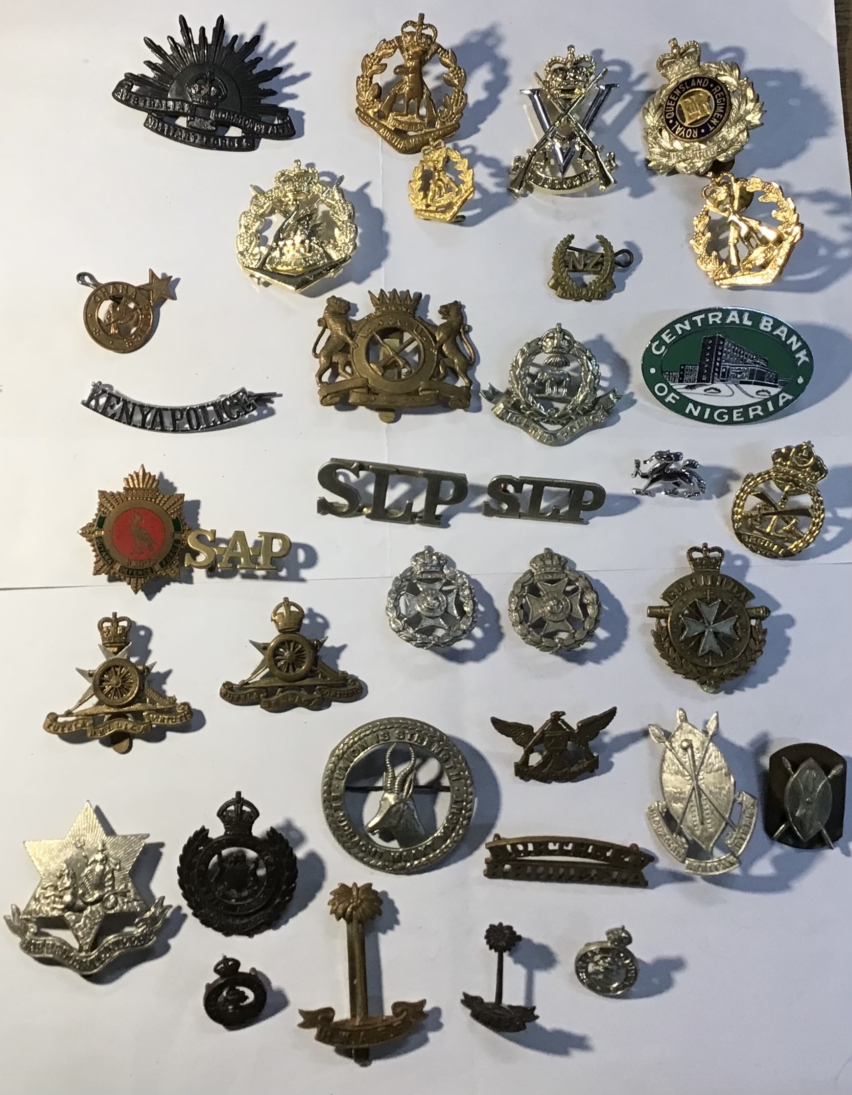Collection of Commonwealth and Colonial Cap & Uniform badges.
