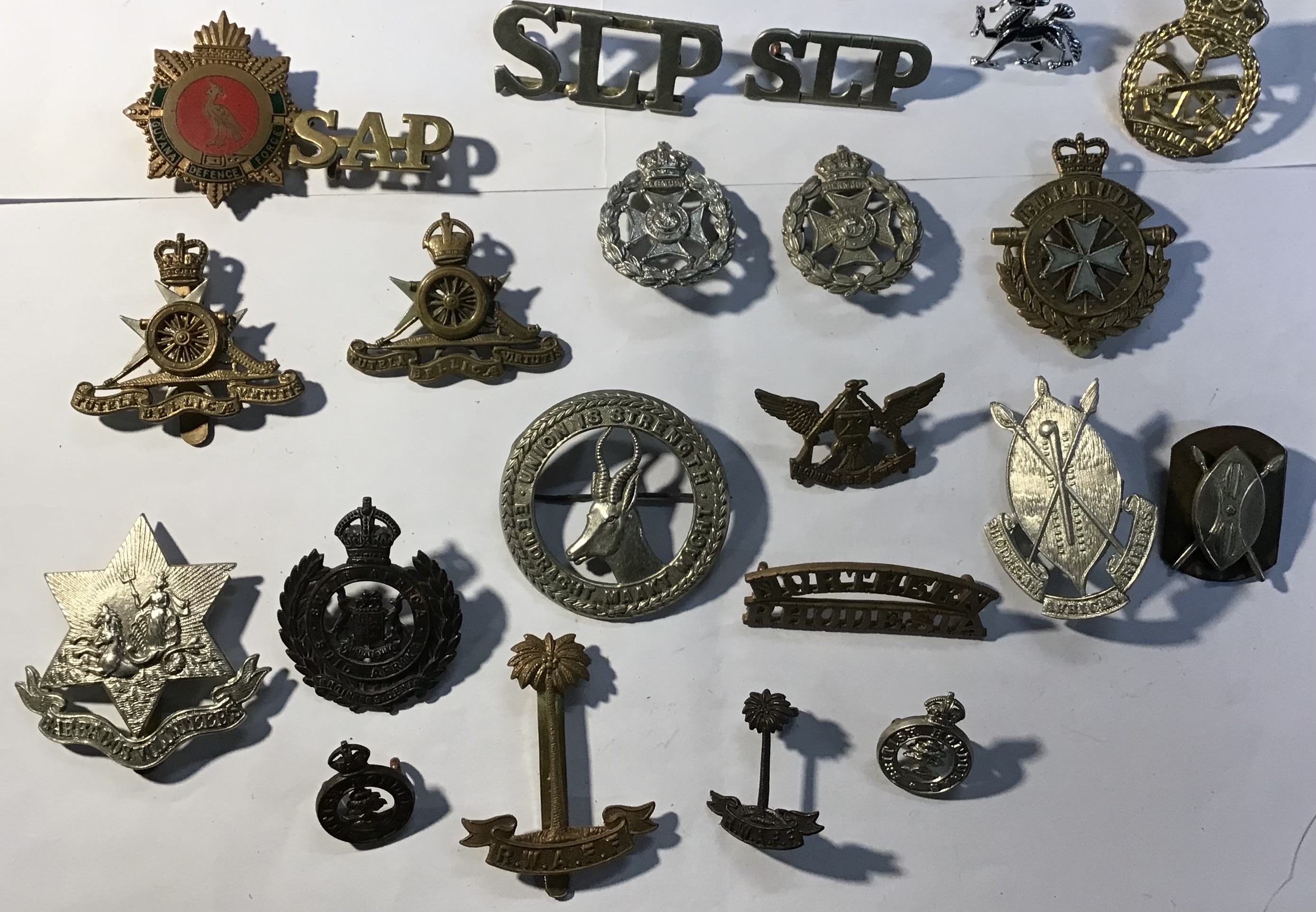 Collection of Commonwealth and Colonial Cap & Uniform badges.
