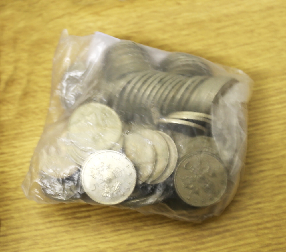 A collection of old decimal 5p coins used for amusement machines. Two ...