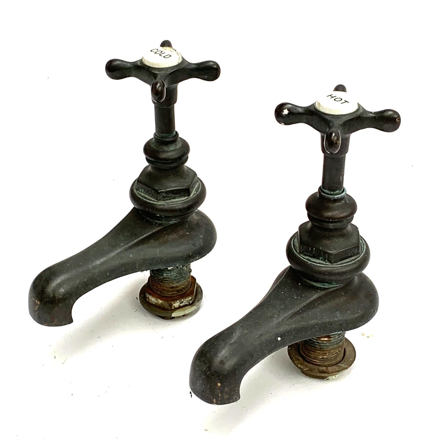A pair of Victorian bronze bath taps with ceramic labels (cold af ...
