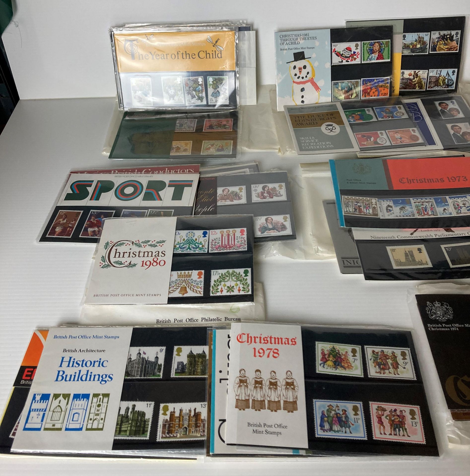 Sixty assorted packs of British Mint Stamps (1973-1981) including ...