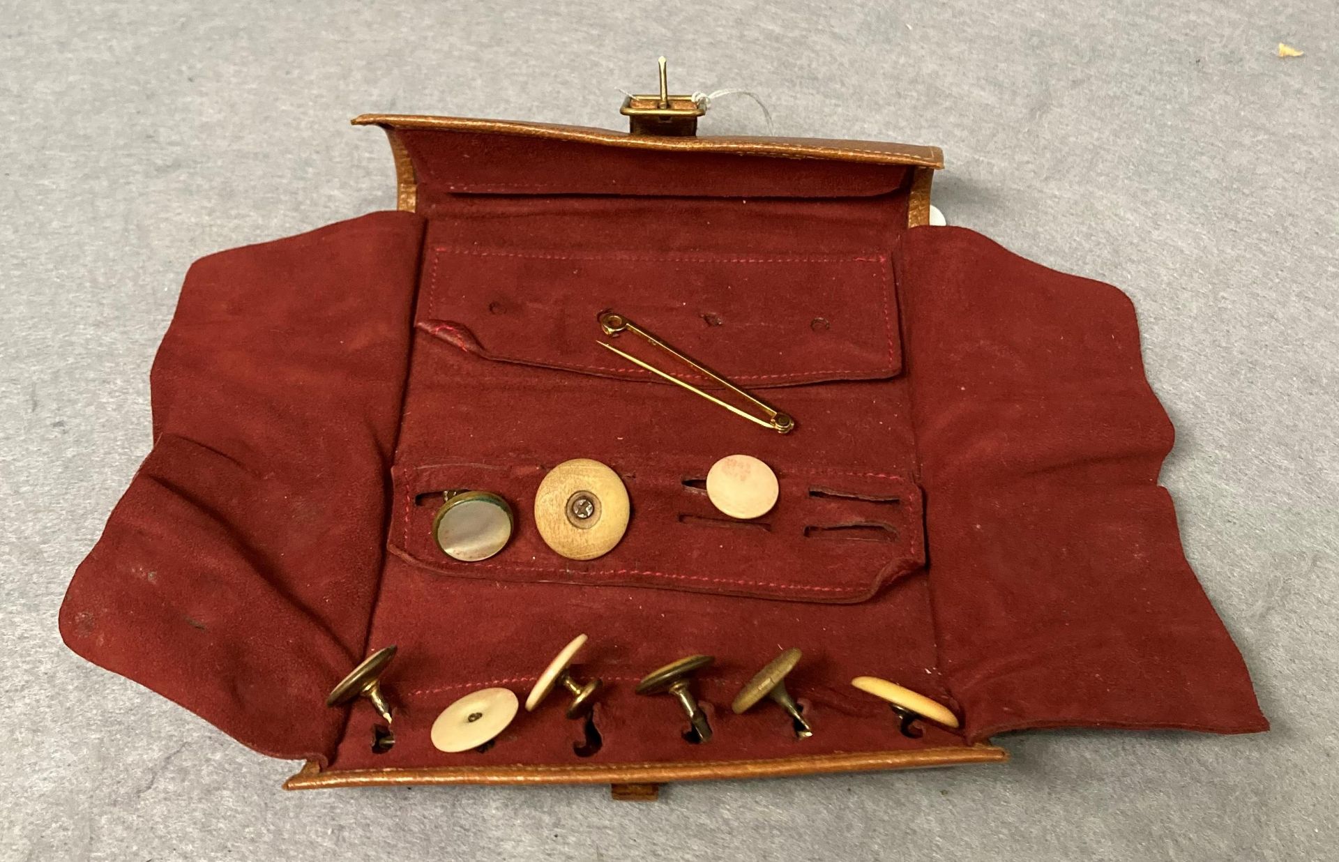 Brown leather roll-up case with a 9ct gold (1.5g) stock pin/tie pin and ...