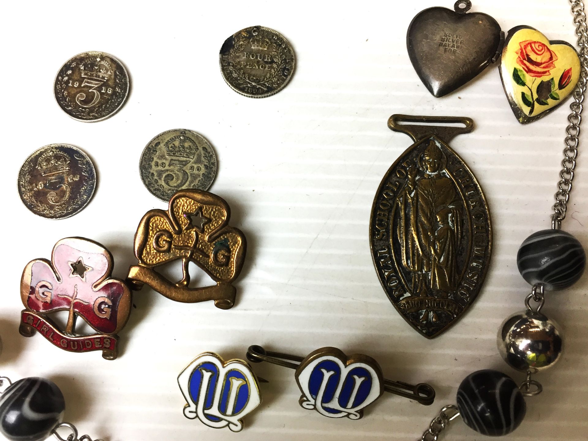 Box containing twenty items including three silver threepenny bits and ...