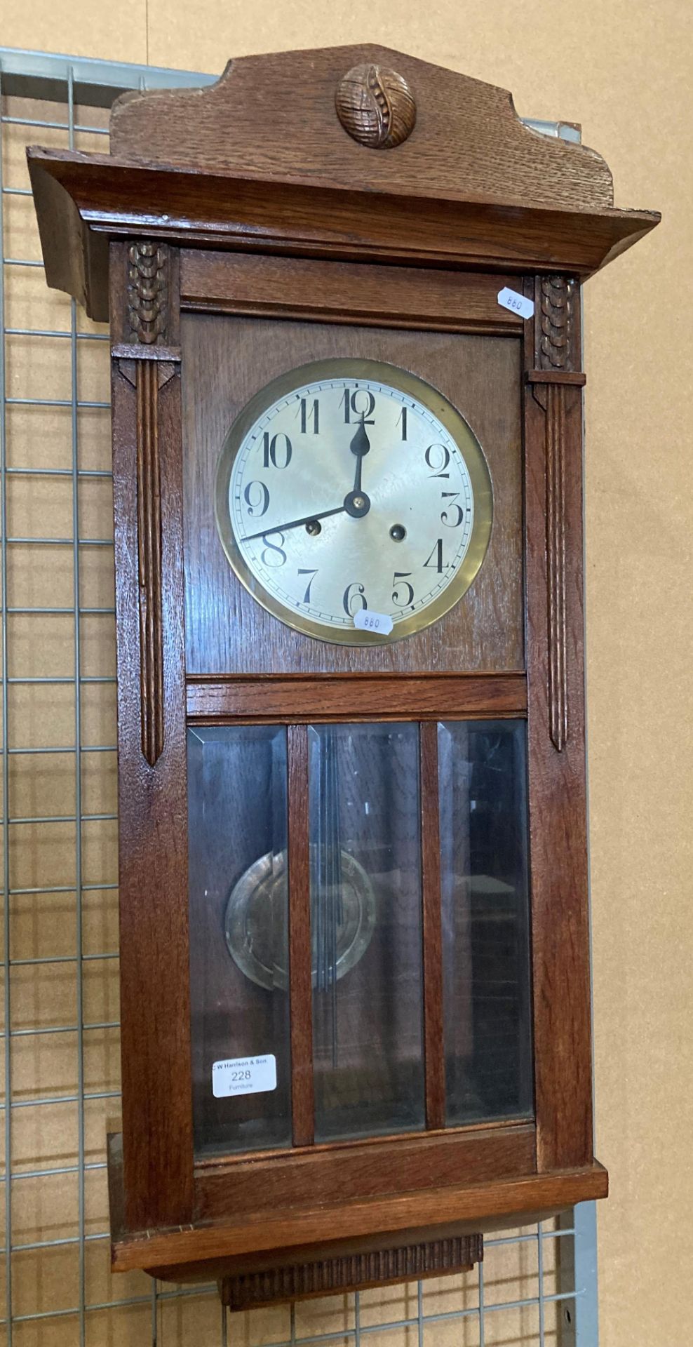 An oak cased wall clock, 80cm (top loose) (Saleroom location: S3 Ent)