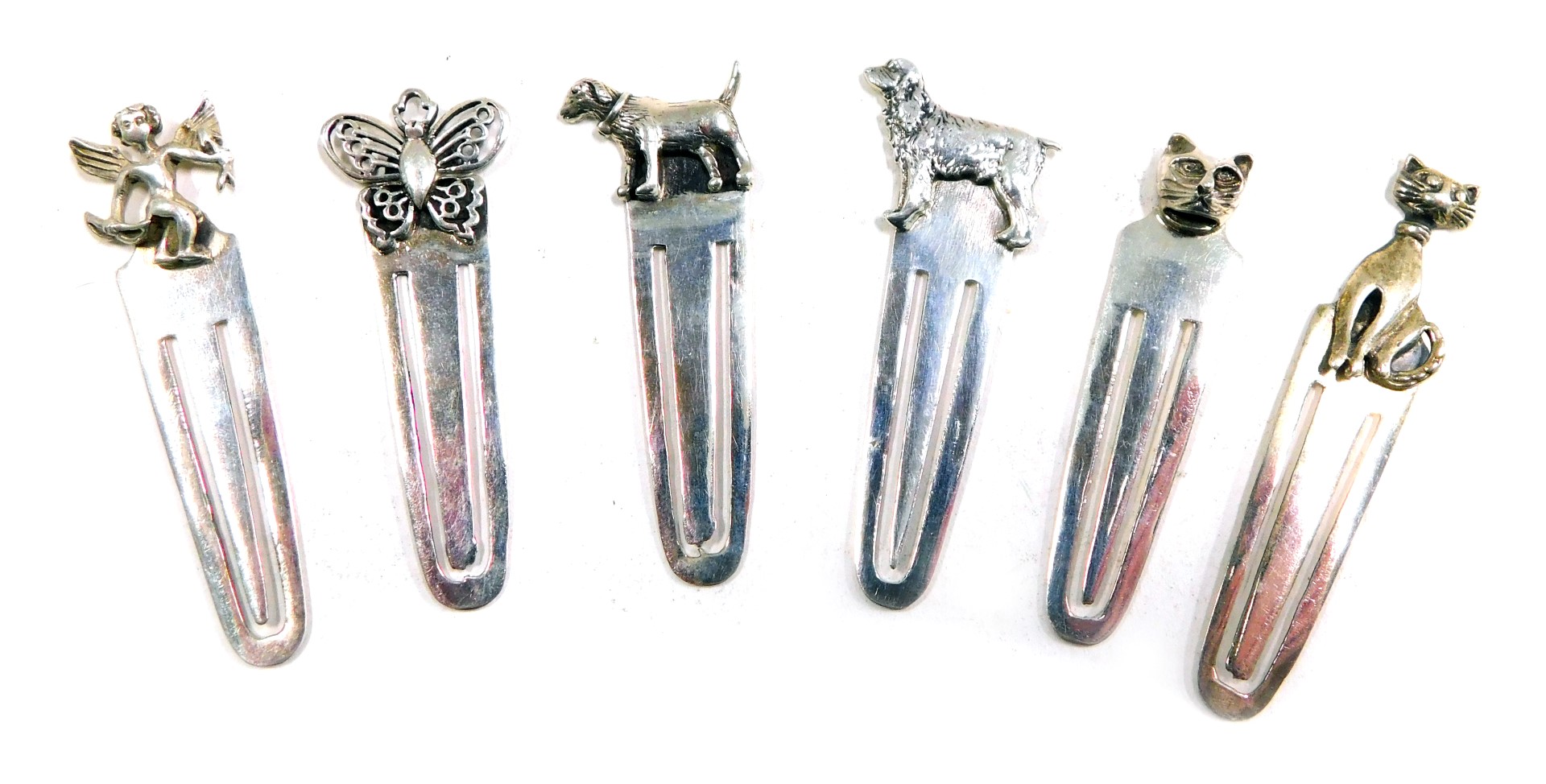 Six silver bookmarks, each end cast with a cat face, dog, cherub, dog ...