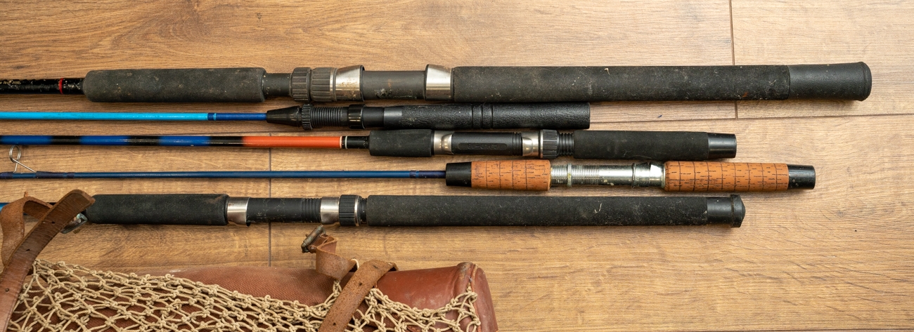 A quantity of vintage fishing equipment, to include five rods, together ...