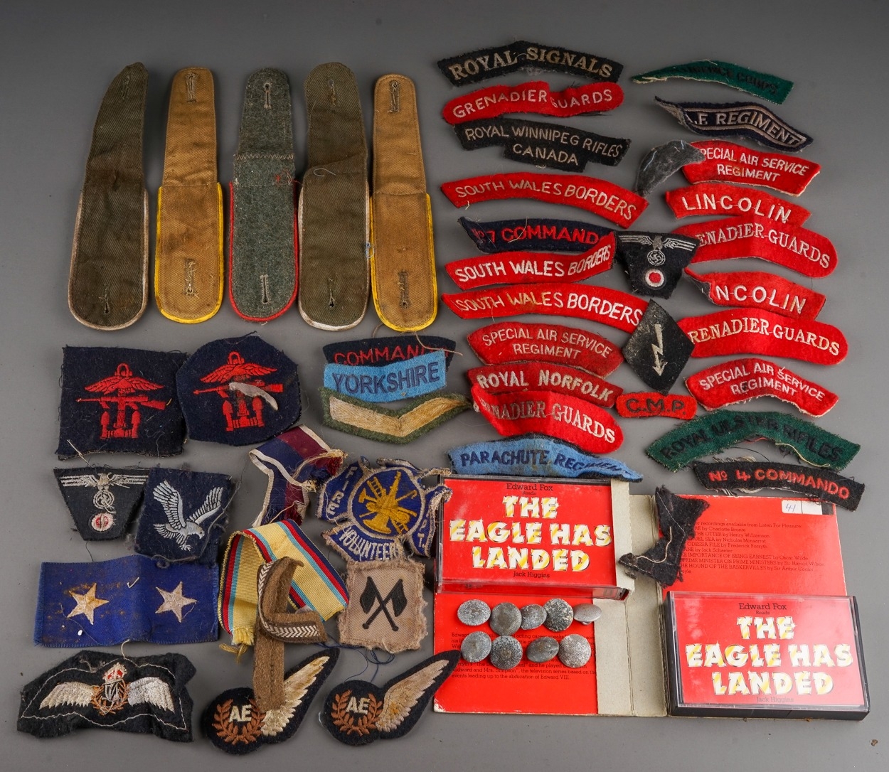 Tin containing a quantity of WW2 era cloth patches including NZ ...
