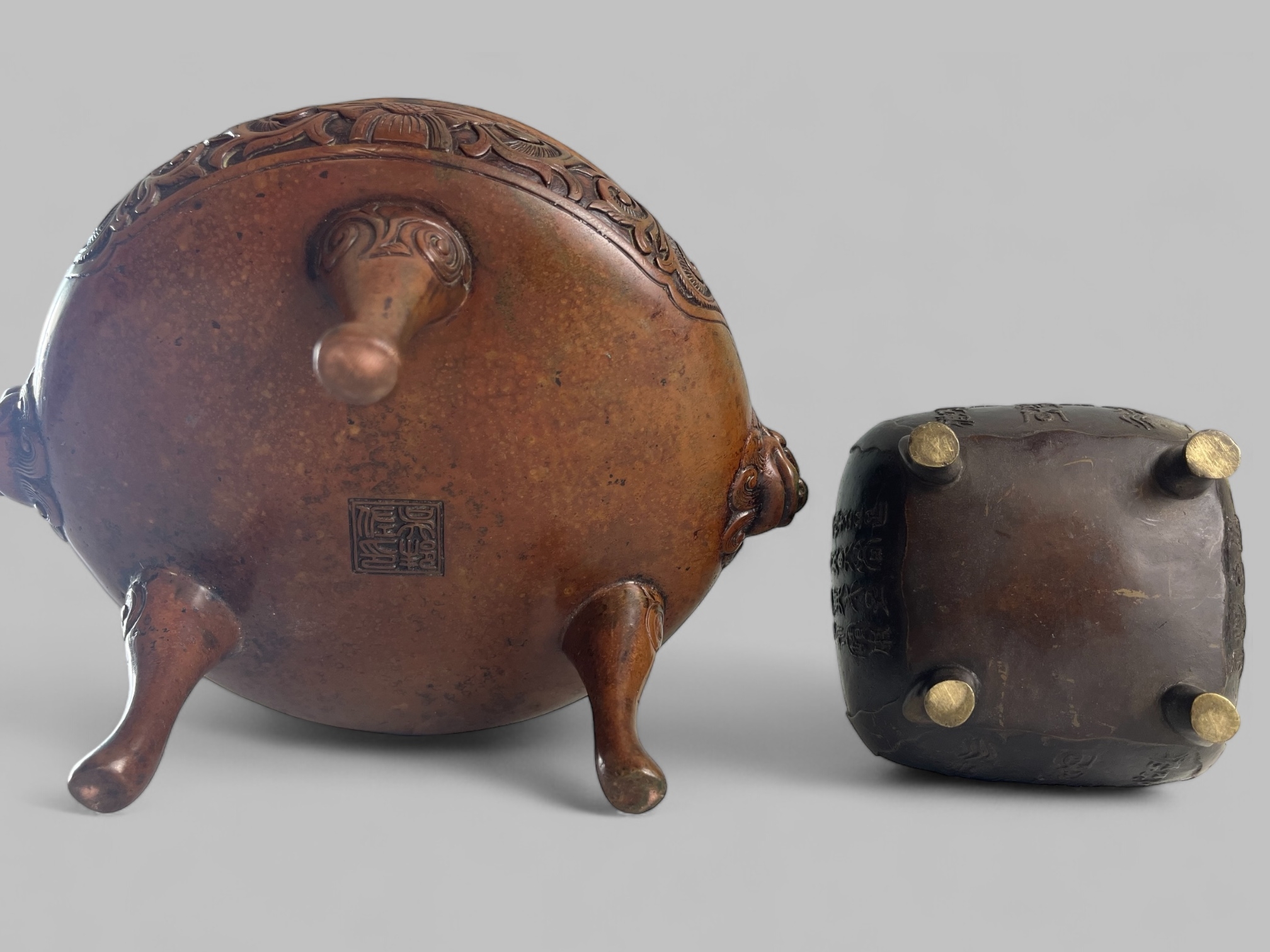 A Chinese bronze tripod censor. Scrolling foliate design, with twin ...