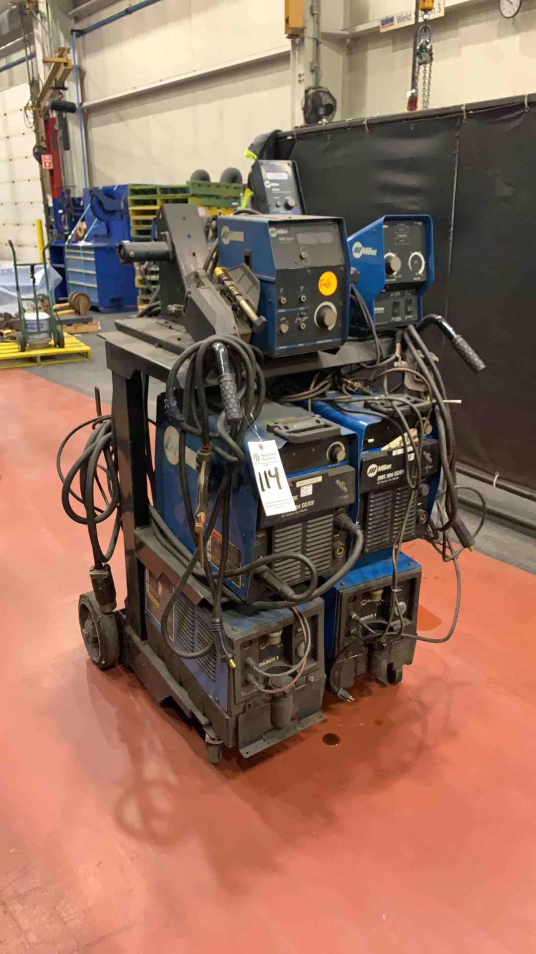 DUAL MILLER WELDING STATION WITH (2) XMT 304 WELDERS, (2) WIRE FEEDERS ...