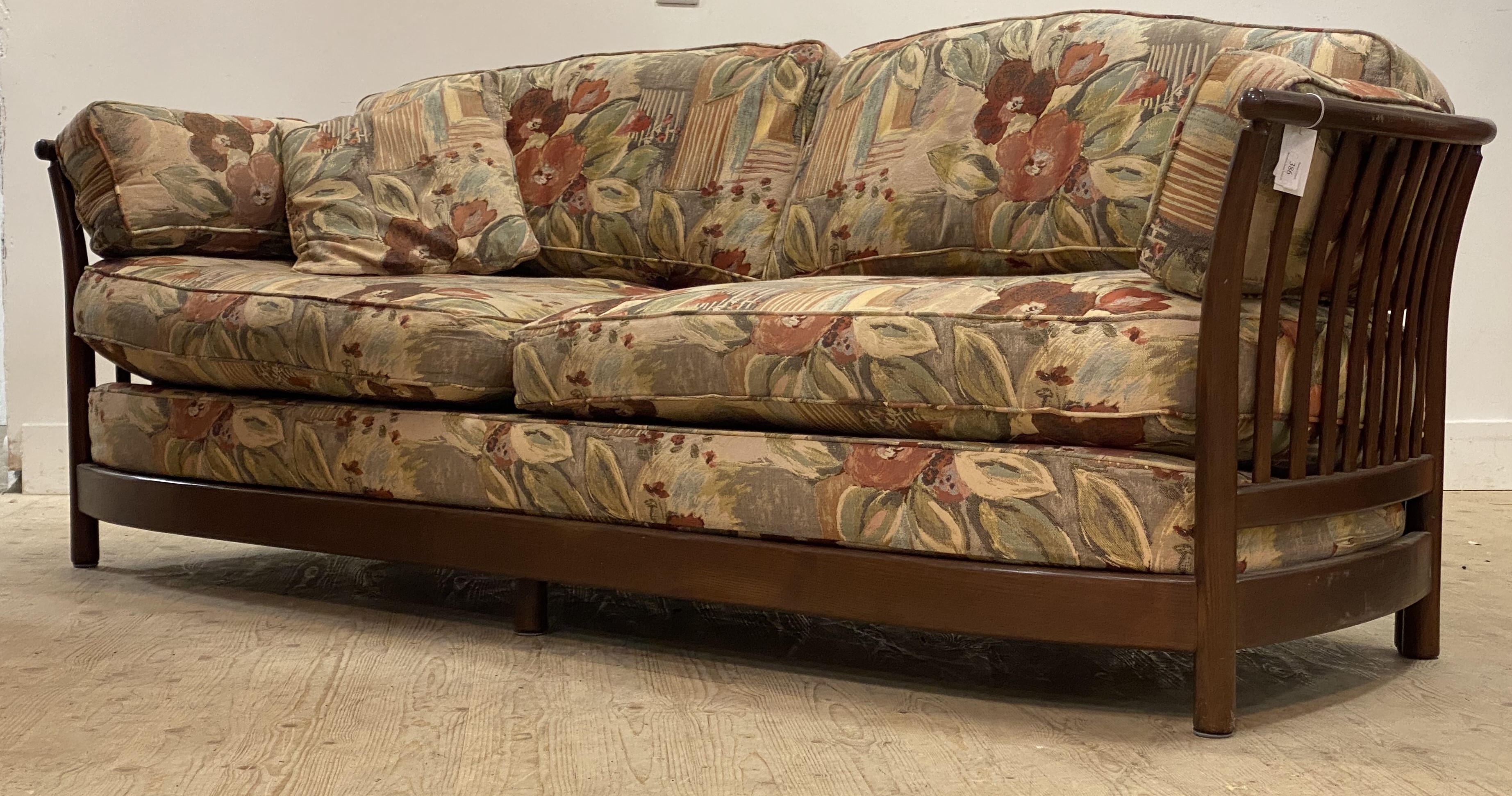 Ercol, a vintage three seat sofa, with spar sides and back, squab ...