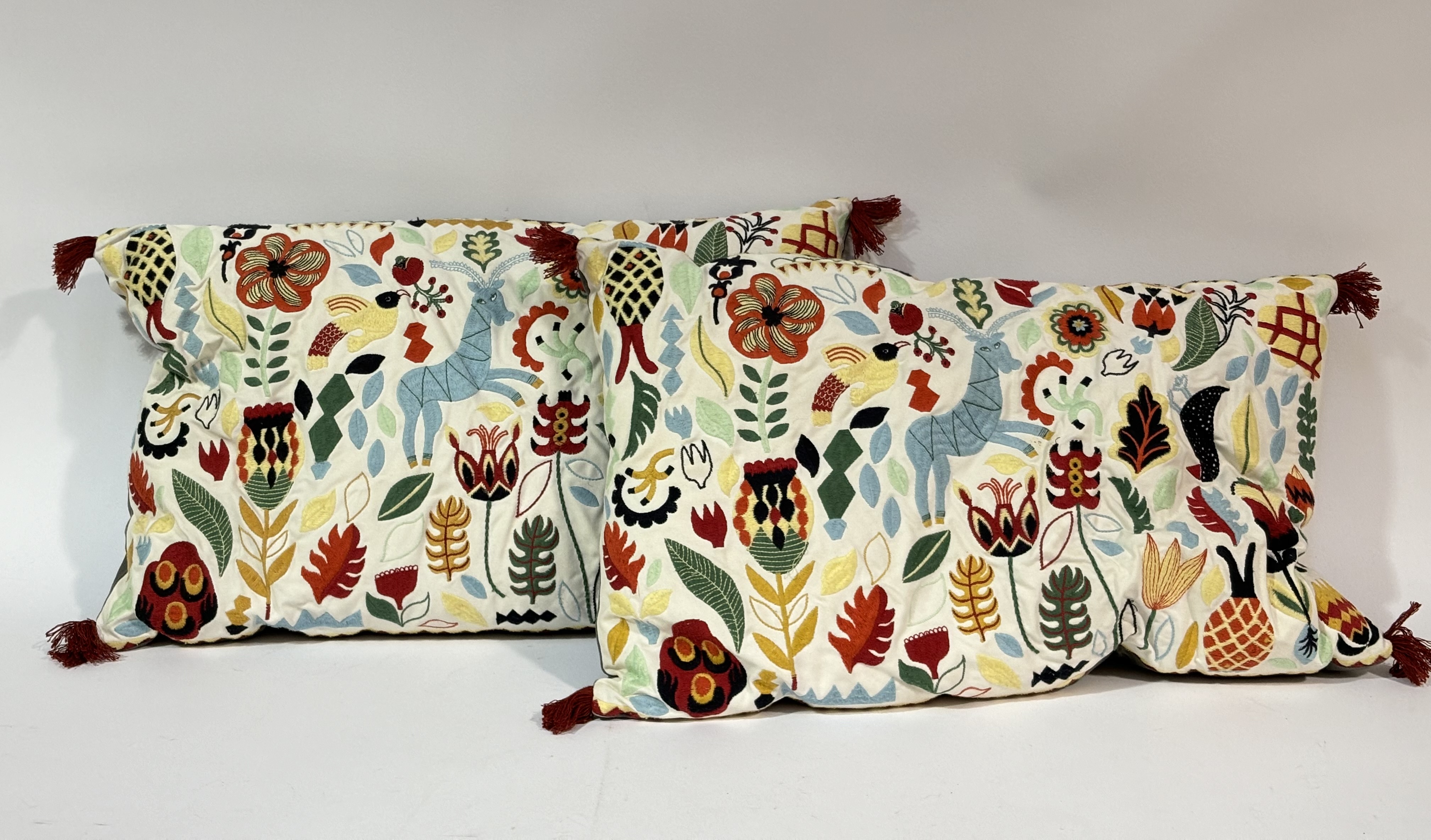A pair of embroidered decorative duck feather throw cushions, decorated ...