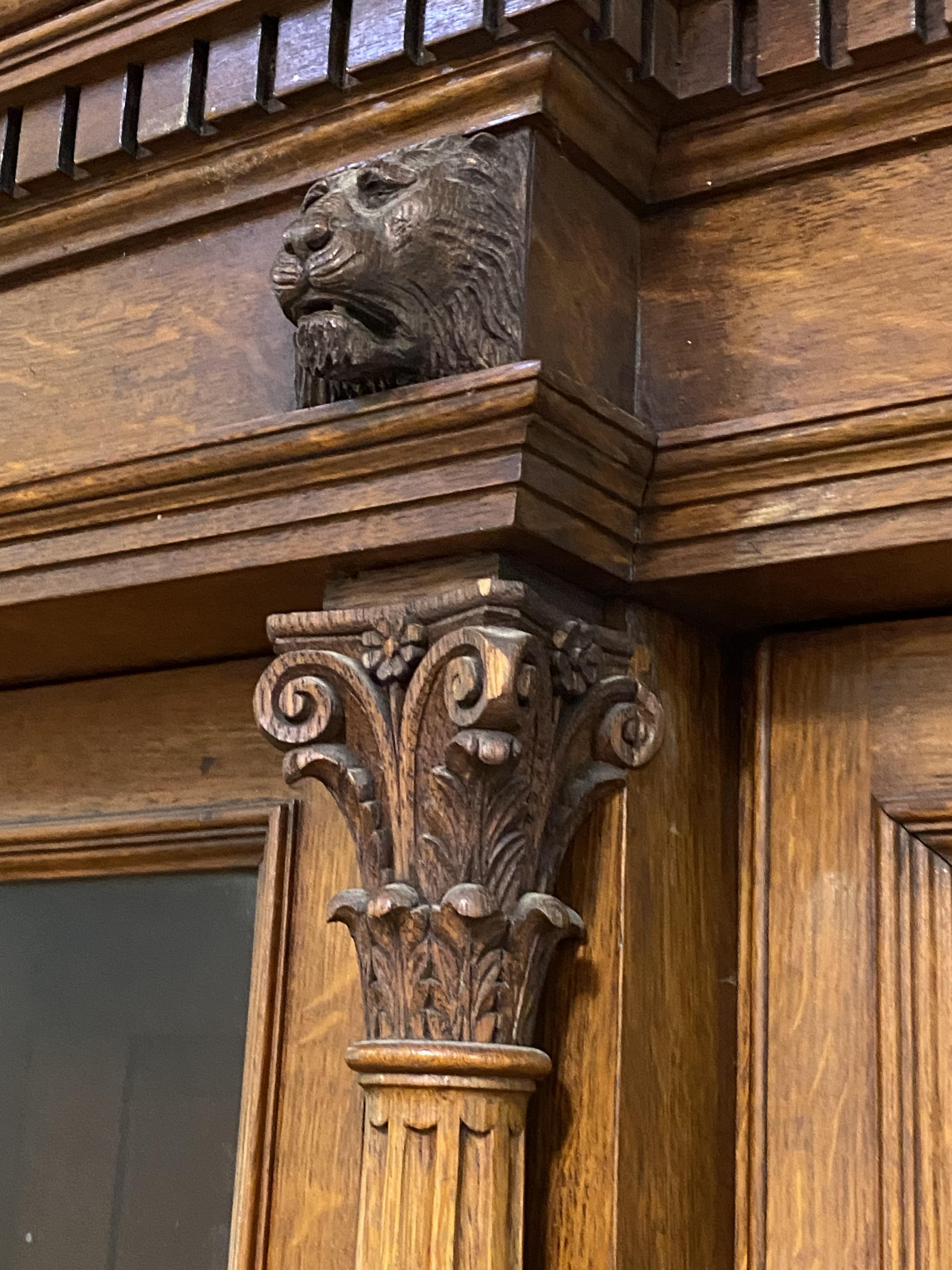 A large Victorian oak breakfront bookcase, the dentil cornice above a ...