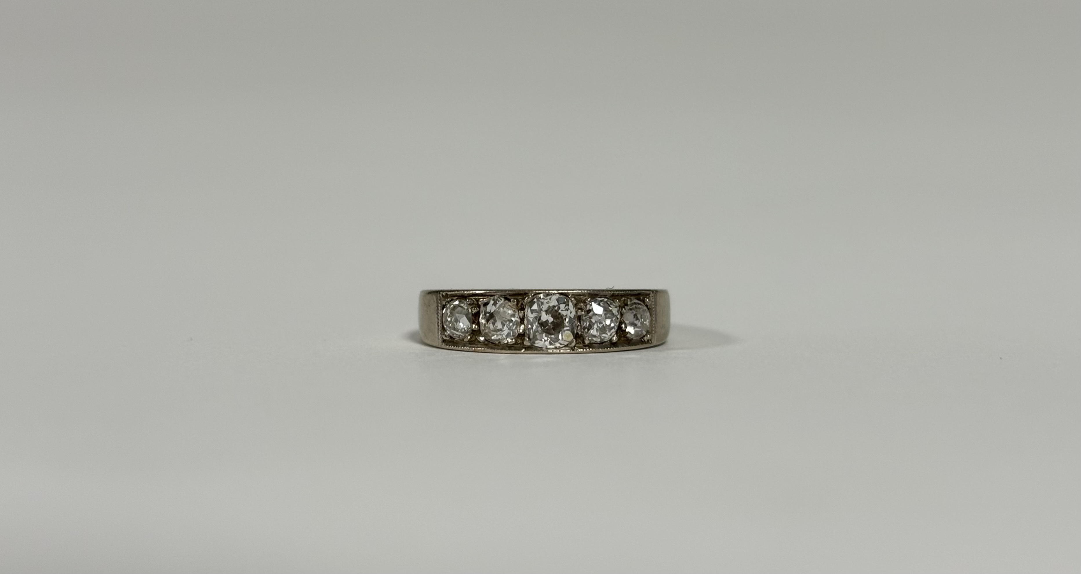A five-stone diamond ring, the graduated round brilliant-cut stones ...