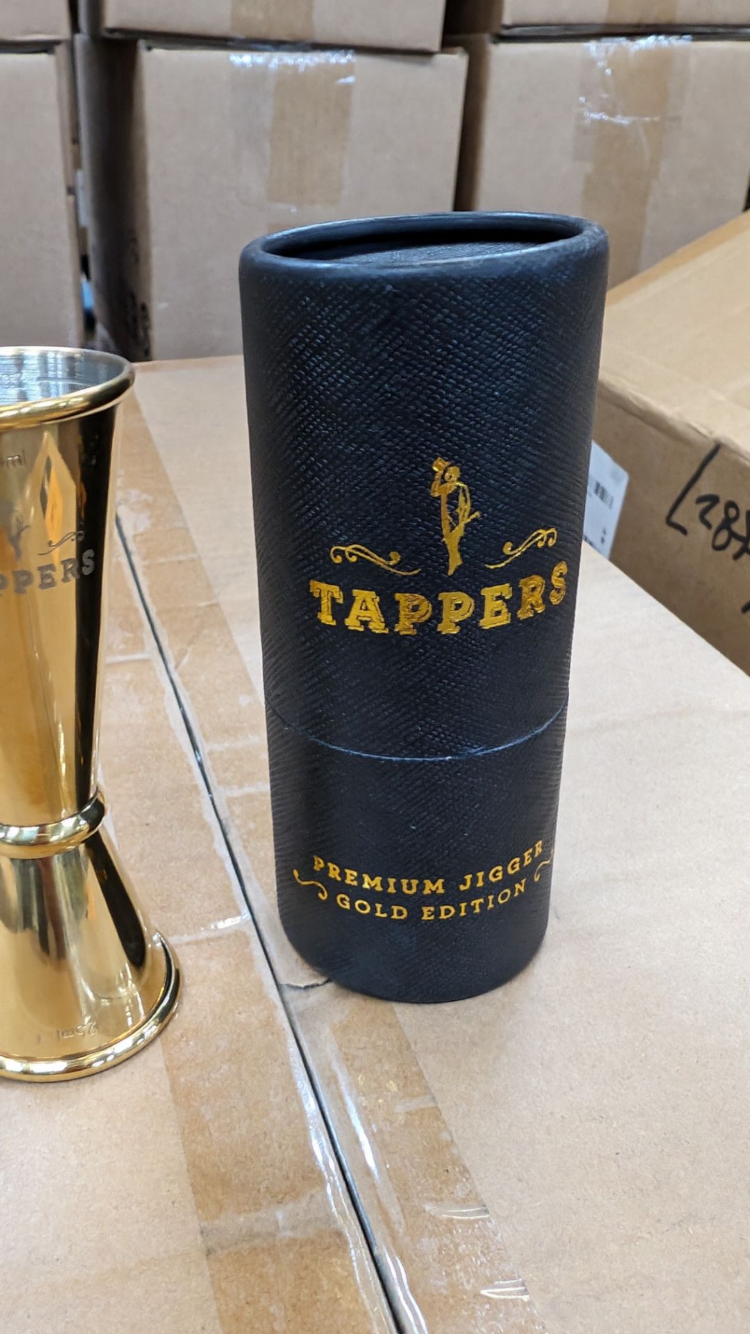 100 off Tappers branded gold jiggers - this lot comprises 1 premium ...
