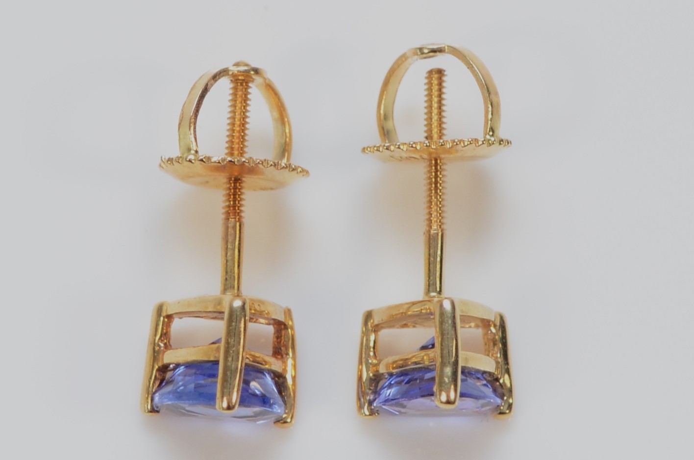 A pair of 18ct gold trilliant cut tanzanite stud earrings, earring ...