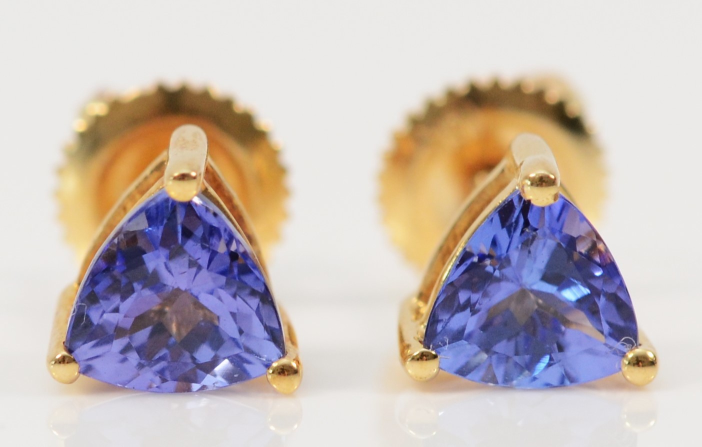 A pair of 18ct gold trilliant cut tanzanite stud earrings, earring ...