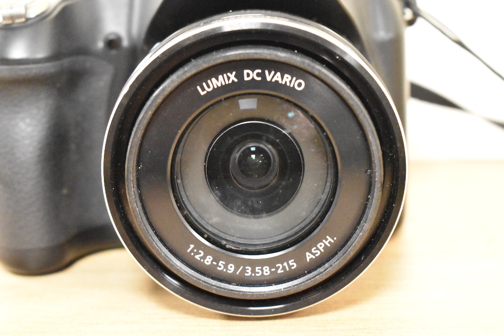 A Panasonic Lumix DMC FZ72 digital camera with charger having Lumix DC ...