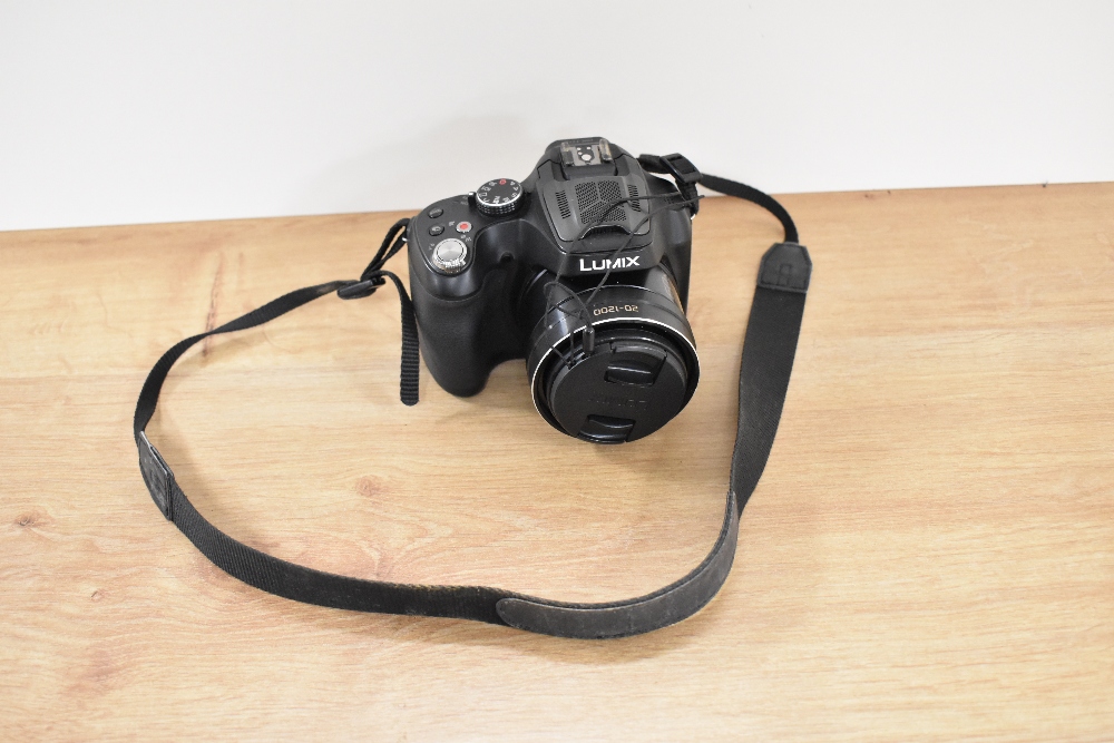A Panasonic Lumix DMC FZ72 digital camera with charger having Lumix DC ...