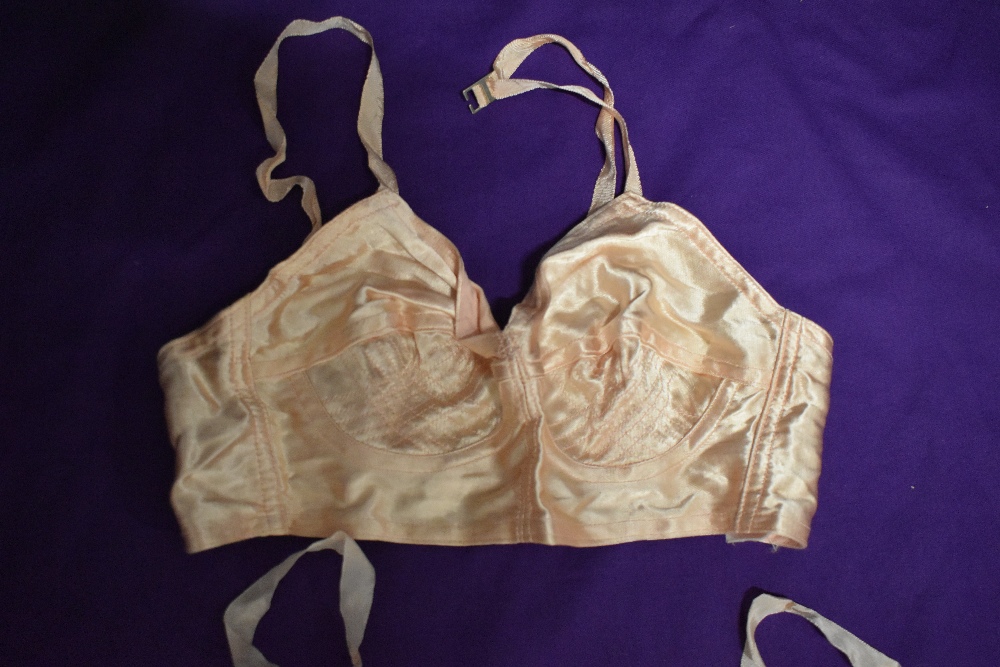 Fourteen vintage 1940s and 50s bras, some multiples of the same style ...