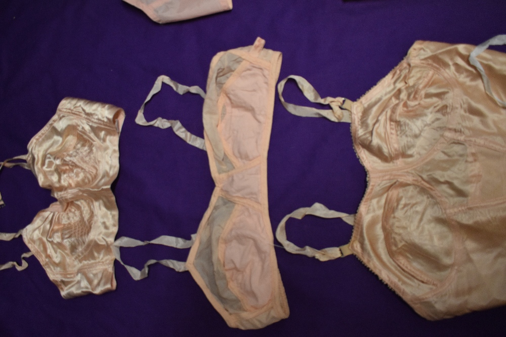 Fourteen vintage 1940s and 50s bras, some multiples of the same style ...