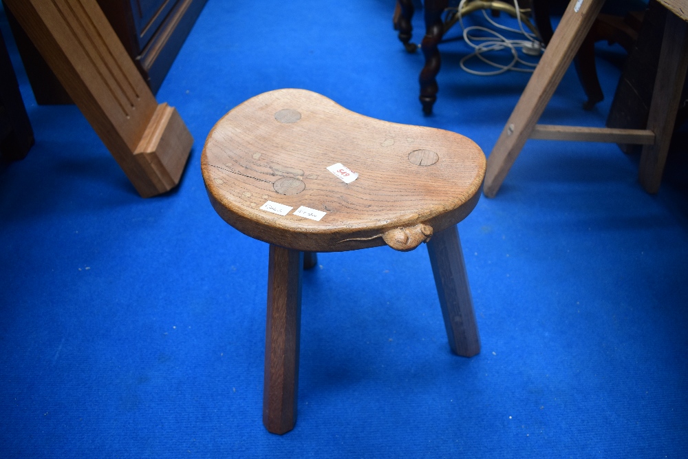 An Arts and Crafts golden oak three legged stool by 'Mouseman' Thompson ...