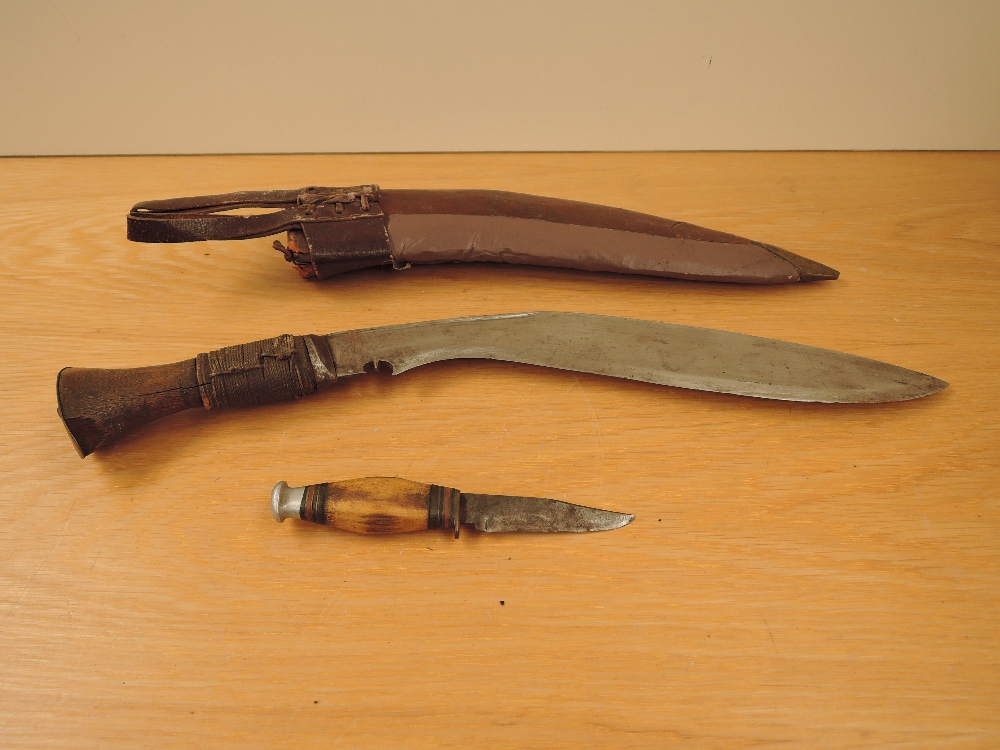 A Gurkha Kukri Knife with curved single edge blade and horn hilt in ...
