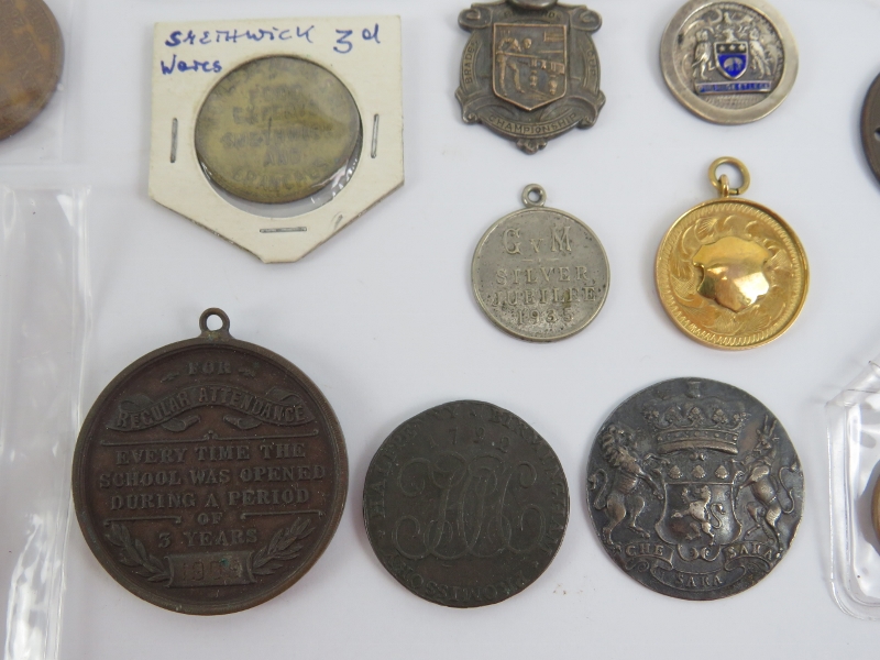 A collection of antique and vintage coin tokens and medallions, 18th ...