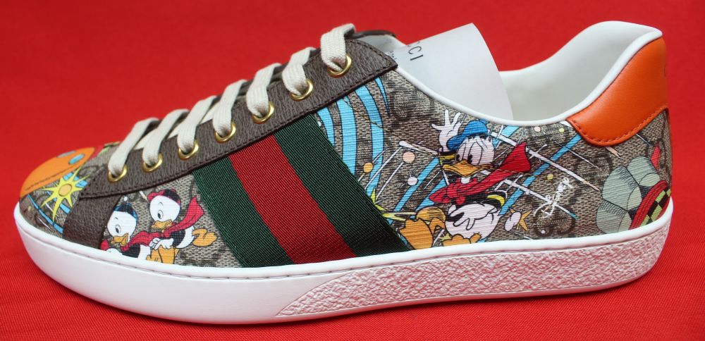 A pair of Gucci Donald Duck trainers, boxed, size 71/2 The sole has a 7 ...