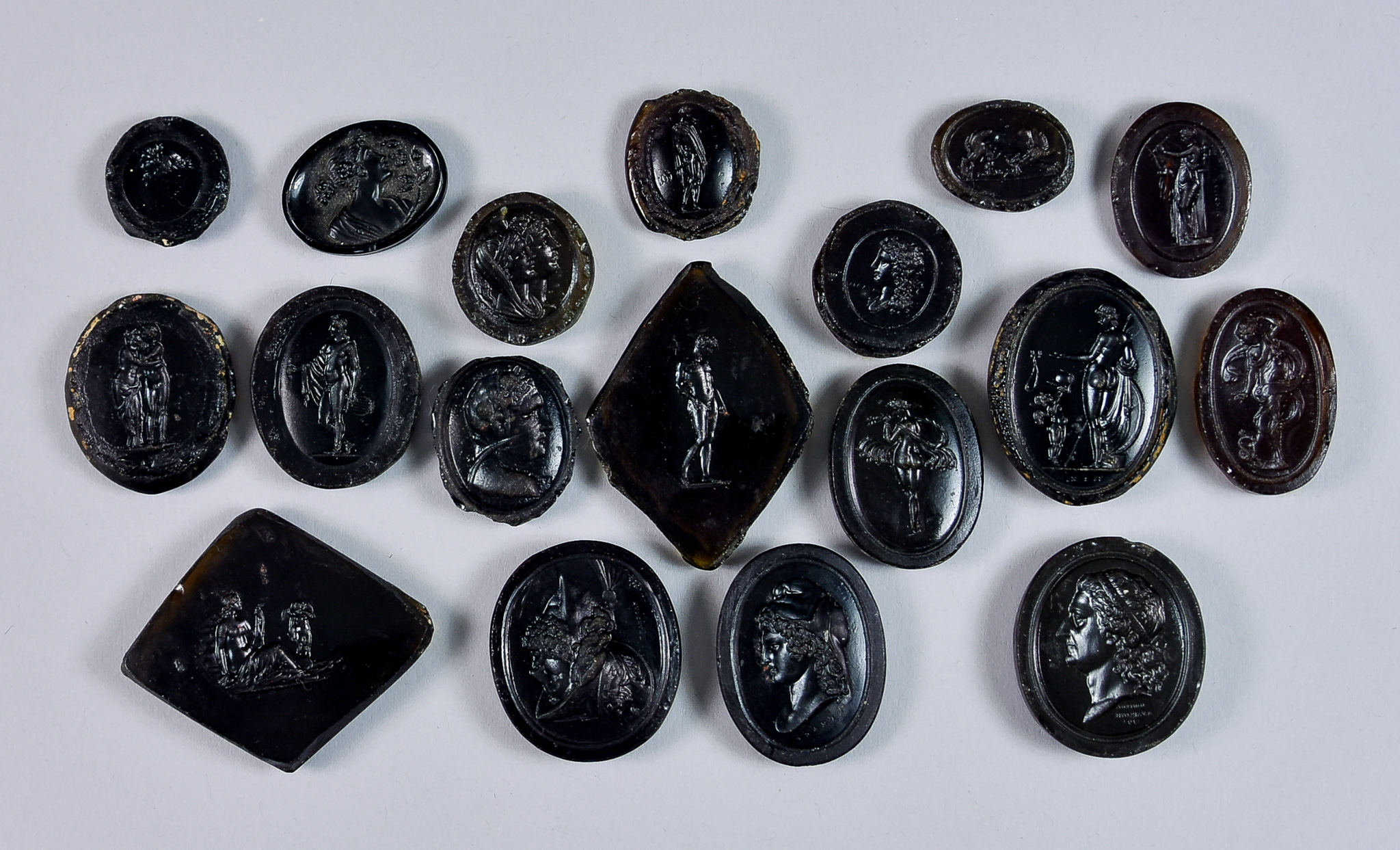 A Collection of Eighteen Italian Grand Tour Brown Glass Intaglios, Late ...